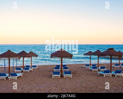 sunset beach with umbrellas and sunbeds without tourists Stock Photo ...