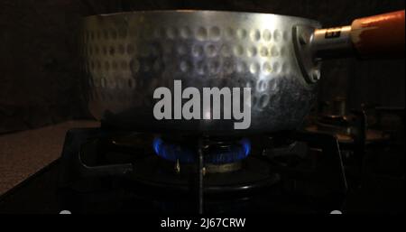 Ignition of the heat under the pot in the kitchen Stock Photo - Alamy