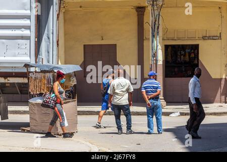 People wearing face masks walk in Tokyo's Shibuya area on Dec. 28, 2020 ...