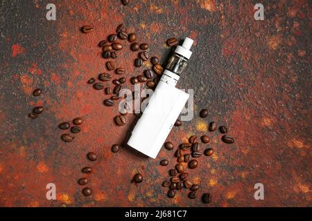Modern vape mod and coffee beans on color background, closeup Stock ...