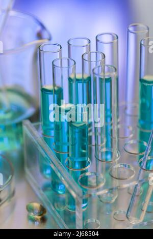 Neatly arranged test tubes containing blue reagent in chemistry ...