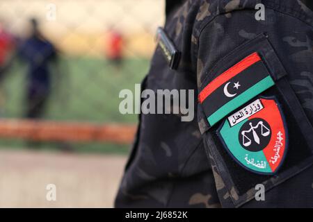 The logo of the judicial police in Libya appears guarding the prison as ...