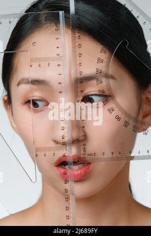 Do facial plastic young woman with a ruler Stock Photo - Alamy