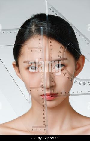 Do facial plastic young woman with a ruler Stock Photo - Alamy