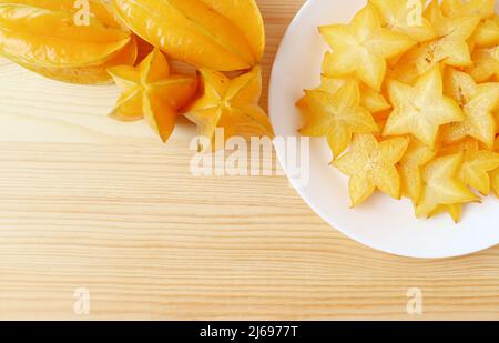 Heap of Fresh Ripe Starfruit with a Plate of Mouthwatering Juicy Slices ...