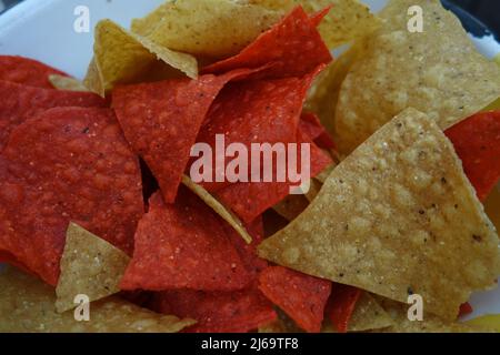 Orange and yellow nacho chips as a close up Stock Photo - Alamy