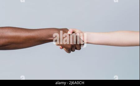 Helping hands, Rescue gesture. African and caucasian hands. Giving a ...