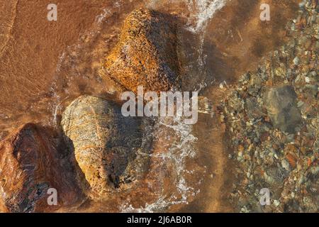 Directly Above Shot of Small Waves Rolling into Beach Dotted with ...