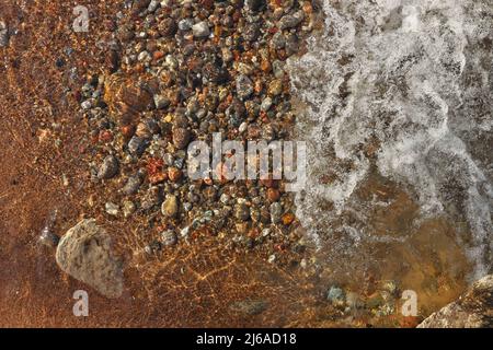 Small Waves Rolling into Sandy Beach Dotted with Colorful Pebbles ...