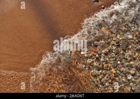 Small Waves Rolling into Sandy Beach Dotted with Colorful Pebbles ...