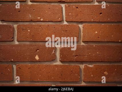Bright red clay bricks wall flat background texture pattern. Vertical ...