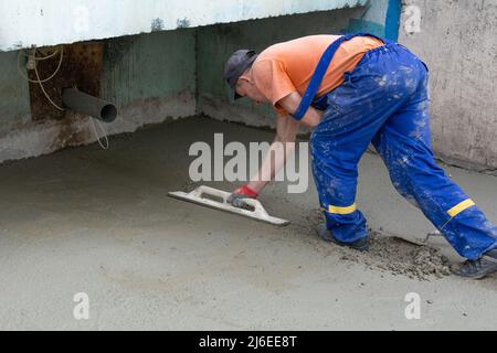 Stormwater construction. An anonymous male construction worker in blue ...
