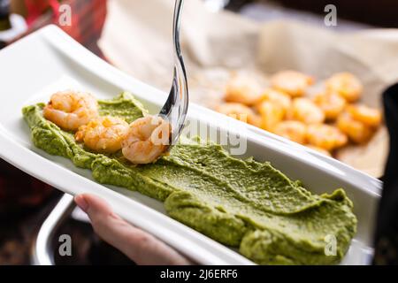 fried prawns on sweet potato puree Stock Photo - Alamy