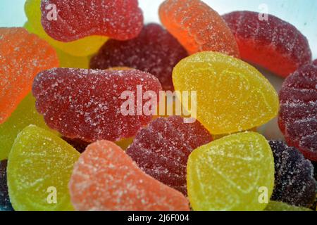 Multi-colored sweets in the form of fruits of different colors: red ...