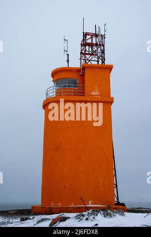 Photograph of the colorful Hvalnes Lighthouse on the southern coast of ...