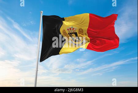 official flag of Royal ensign 1858, Belgium at cloudy sky background on ...