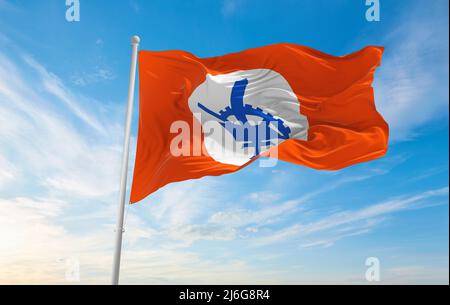 official flag of Verdinaso, Belgium at cloudy sky background on sunset ...