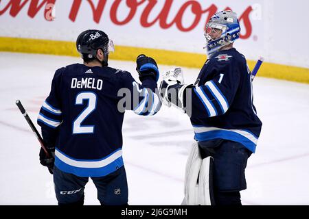 Winnipeg Jets goaltender Eric Comrie makes a glove save against the ...