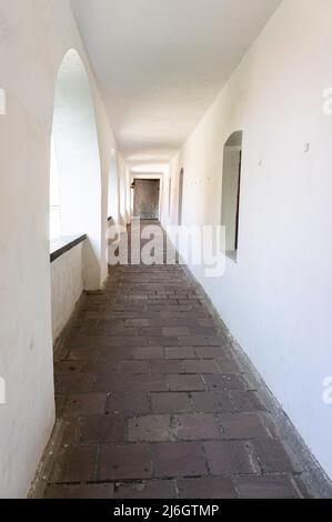 Room with door to balcony and narrow long corridor in perspective in ...
