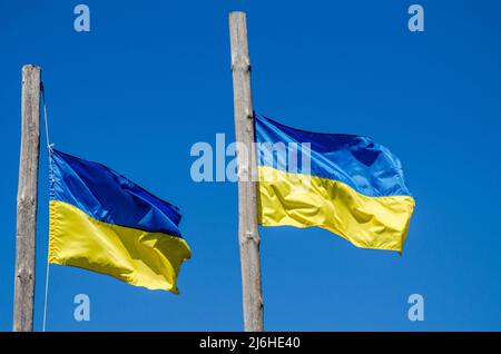 Ukrainian national official flag on blue sky background Stock Photo - Alamy