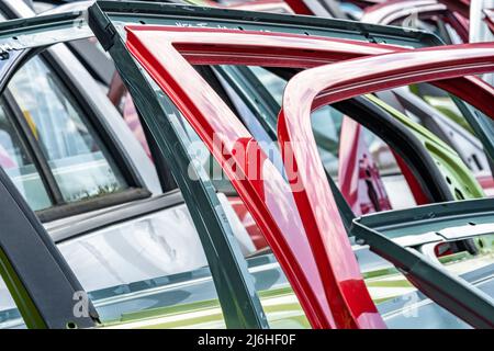 different colored car doors at a car junkyard Stock Photo - Alamy