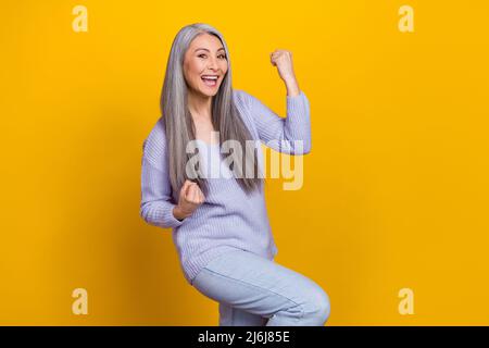 Photo of excited shiny lady dressed red tank top pointing fingers back ...
