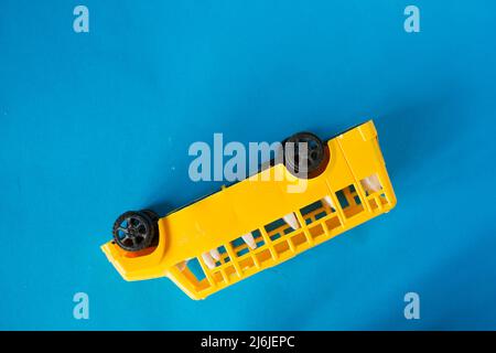 Accident with shcool bus concept. Toy bus upside down Stock Photo - Alamy