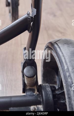 Broken chassis of a baby stroller, damage to the crossbar of the metal ...