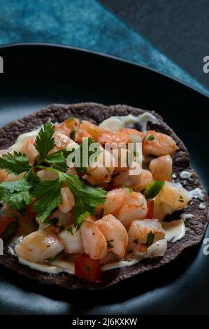Red shrimp ceviche and blue corn tostadas Stock Photo - Alamy