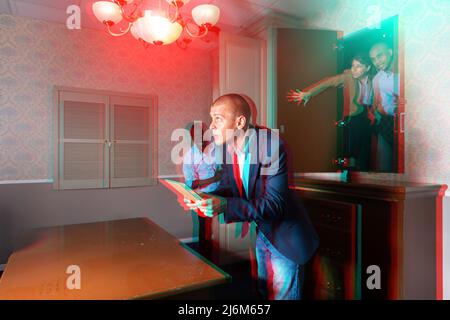 Four friends in quest room with special light effects Stock Photo - Alamy