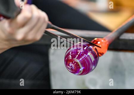 Molten glass being worked into an ornament at melting point Glass ...