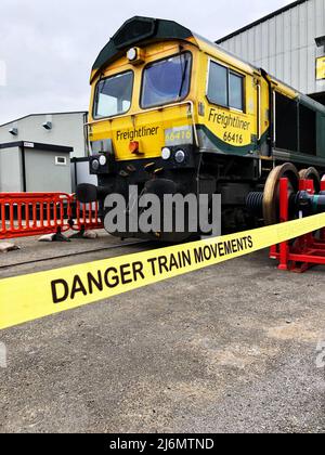 The moving train with a warning sign Stock Photo - Alamy