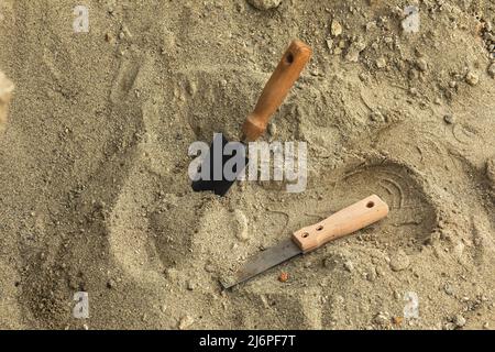 Shovel in the sand.Skeleton and archaeological tools.Digging for ...