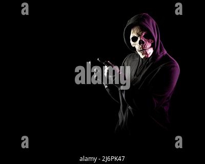 Modern death character on a black background taking notes Stock Photo ...