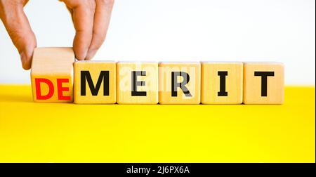 Demerit or merit symbol. Businessman turns wooden cubes and changes the ...