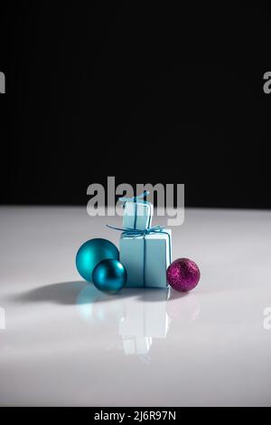 creative minimalistic new year still life with gifts and christmas tree ...