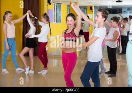 Tweens practicing vigorous dance in class Stock Photo - Alamy