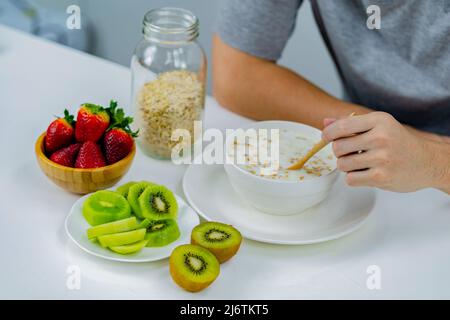 Asian man eating oatmeal for breakfast Stock Photo - Alamy