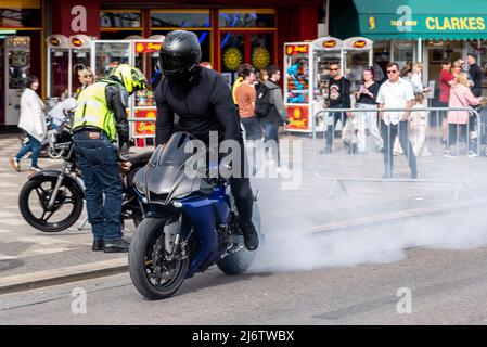 Rider smoking his bike rear tyre after a championship race Stock Photo ...