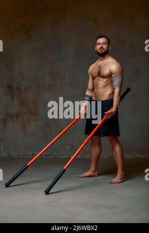athlete men with stick training karate using sports tool in studio on ...