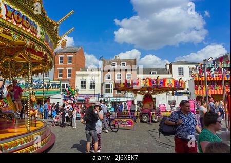 People enjoying the annual May fair in Boston on a sunny springtime day ...