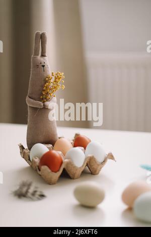 Happy Easter concept. Funny handmade bunny rabbit toy and chicken eggs ...