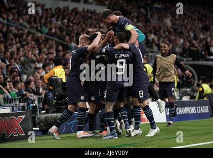Manchester City's Riyad Mahrez is mobbed by team mates after scoring ...