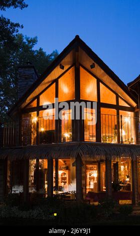 Rear view of modern tropical timber frame style home at dusk Stock ...