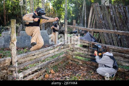 People playing paintball outdoors Stock Photo - Alamy