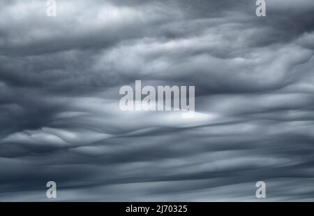 Dramatic sky of altocumulus asperitas clouds over the landscape of ...