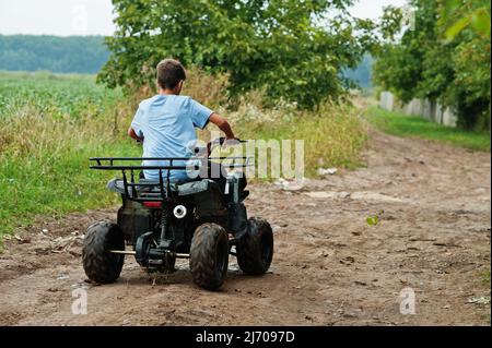 Boy drive four-wheller ATV quad bike Stock Photo - Alamy