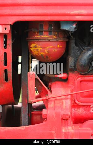 Traditional vintage bright red tractor mechanical engine and frame ...
