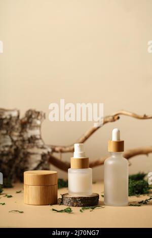 Jar of cosmetic cream with wood podium and palm leaf on grey background ...