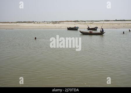 The Ganges with floating boats near Guptar Ghat or Narayan Ghat. Civil ...